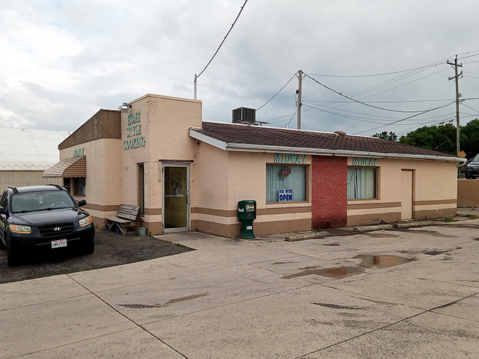 The unassuming exterior of Midway Restaurant stands as a beacon of honest cooking in Kenton, where the "YES WE'RE OPEN" sign might be the best news you'll get all day.