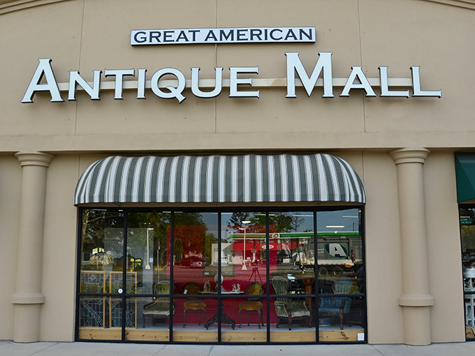 The storefront beckons with its classic striped awning – like a time portal disguised as a strip mall tenant. Treasure awaits!