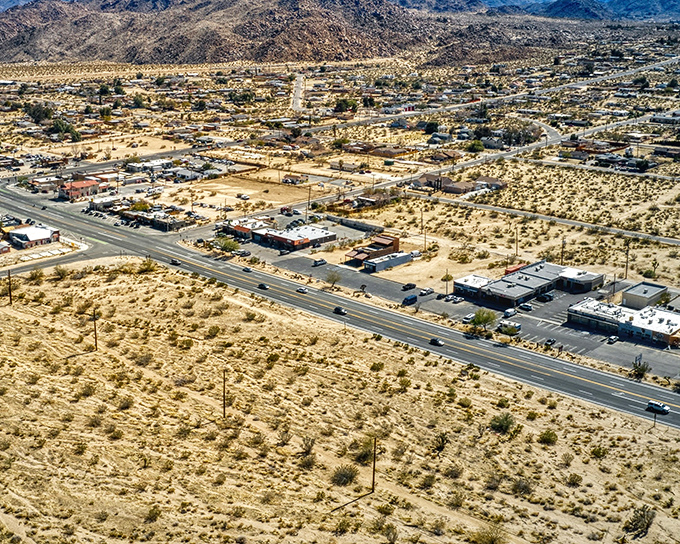 The main drag of Joshua Tree welcomes you with wide-open roads and that quintessential desert town vibe. No traffic jams here—just endless possibilities.