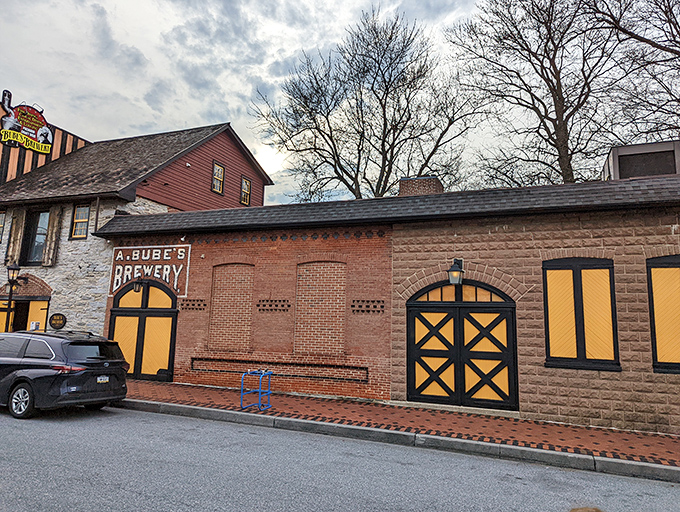 The historic façade of Bube's Brewery stands proudly in Mount Joy, its distinctive yellow and black accents beckoning curious food adventurers from miles around.