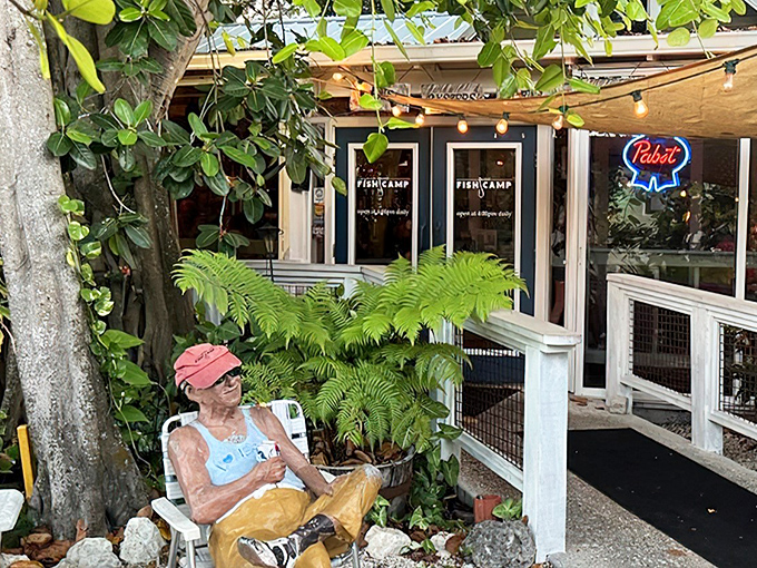 The entrance to Owen's Fish Camp feels like stepping into a Southern novel – complete with a majestic banyan tree standing guard over seafood paradise.