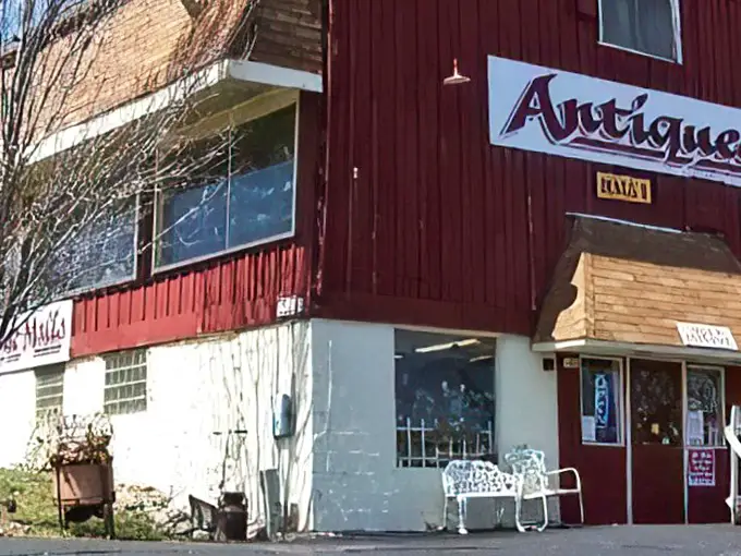 The iconic red barn exterior of Volo Antique Malls stands as a beacon to treasure hunters, promising adventures in nostalgia just beyond those doors.