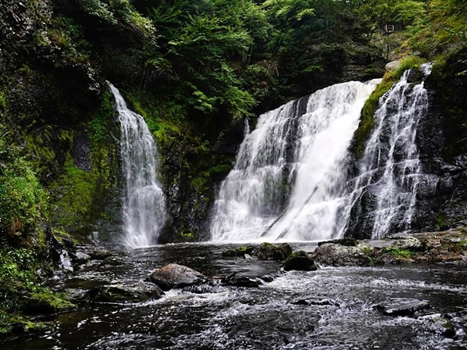 Nature's three-tiered masterpiece puts on a spectacular show, with rushing water carving through ancient rock formations in Pennsylvania's hidden gem.