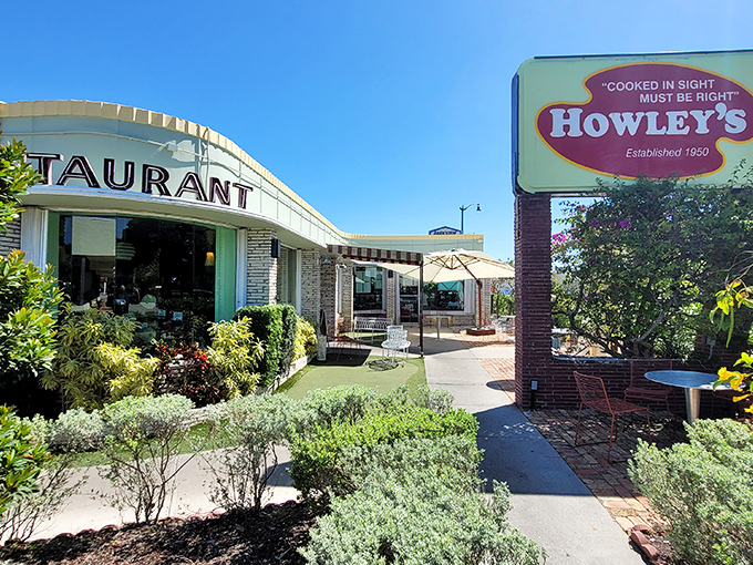 The mid-century modern façade of Howley's stands as a time capsule of Florida cool, complete with lush landscaping that says "come in, relax, you've found your happy place."