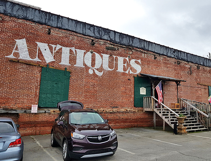 The brick facade with its bold "ANTIQUES" lettering isn't just advertising—it's a siren call to treasure hunters and nostalgia seekers alike.