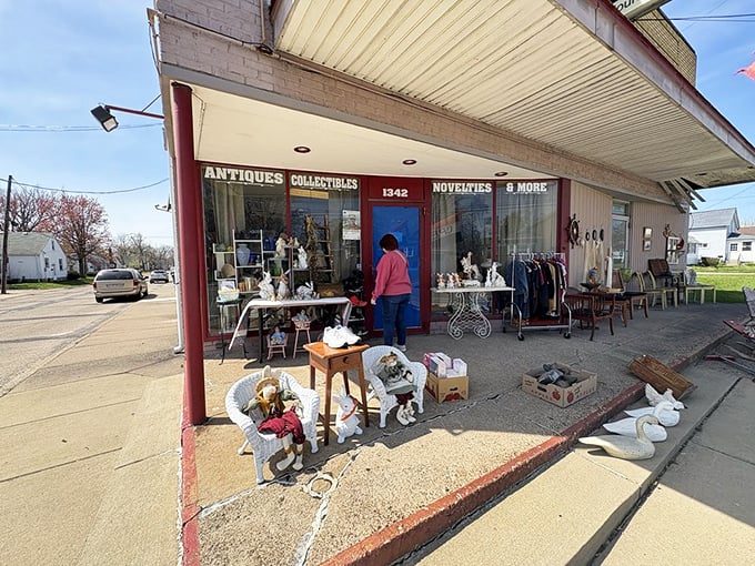 The unassuming storefront beckons with treasures spilling onto the sidewalk. That blue door isn't just an entrance—it's a time portal to yesteryear.