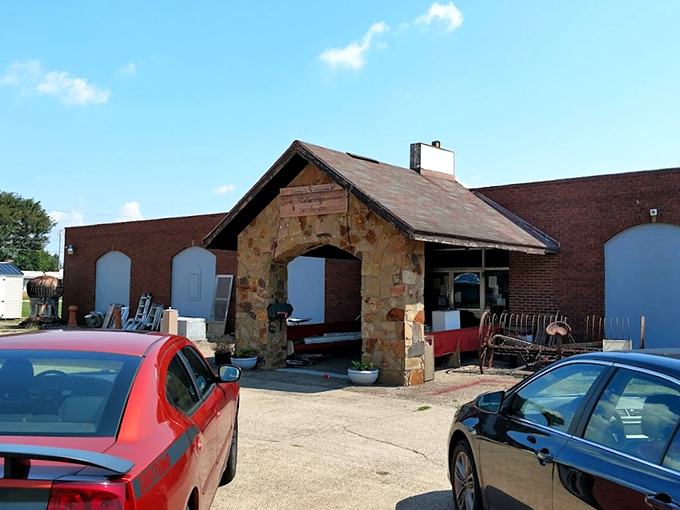 The stone facade of Leroy's Antiques & Collectibles stands like a humble guardian of treasures past, its wooden sign promising adventures in nostalgia beneath the Ohio sky.