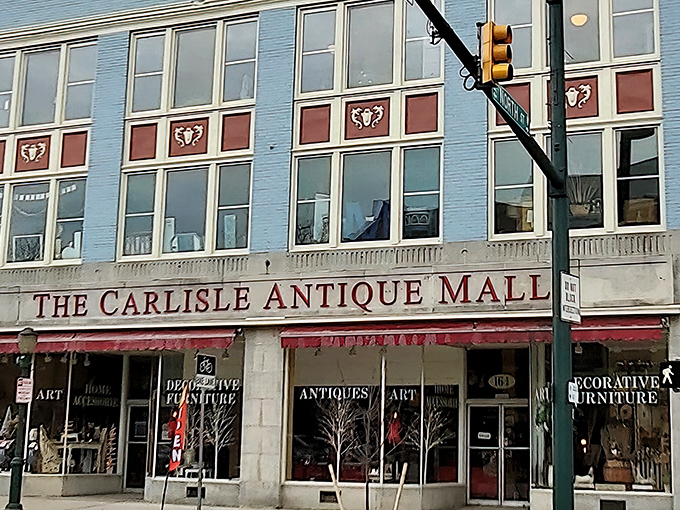 The blue façade of Carlisle Antique Mall stands like a portal to the past, inviting treasure hunters to step through its doors and back in time.