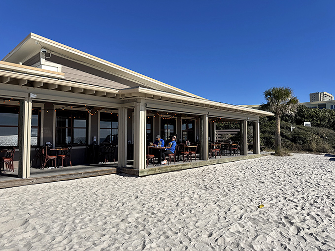 Paradise doesn't need fancy architecture—just a weathered wooden deck, sugar-white sand beneath, and the promise of seafood that was swimming this morning.