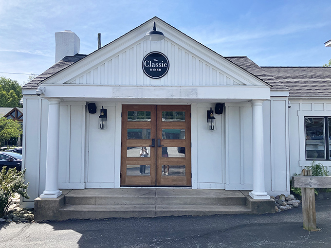 This charming white facade with its welcoming double doors practically whispers "breakfast magic happens here."