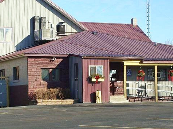 The unassuming exterior of Antlers Supper Club in Bonduel invites you in with its decorative deer statues—a perfect preview of the Northwoods charm waiting inside.