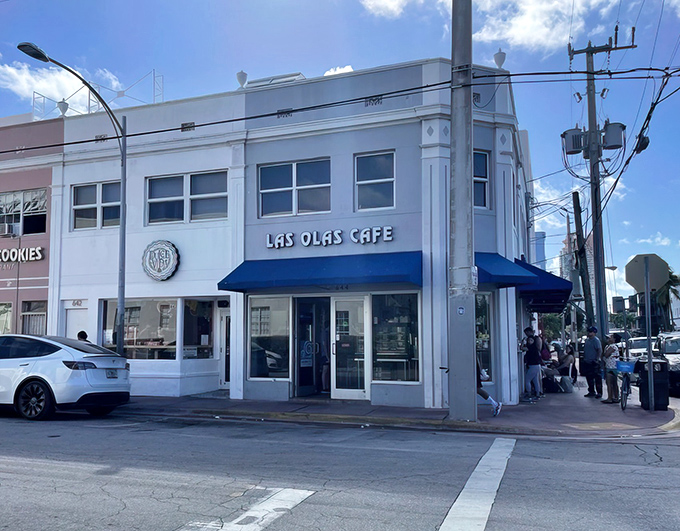 The unassuming white facade with blue awnings of Las Olas Cafe stands like a beacon of Cuban culinary authenticity in Miami Beach's glitzy landscape.