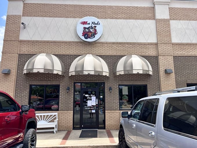 The classic brick exterior with striped awnings isn't just a restaurant—it's a time machine disguised as a diner in Social Circle, Georgia.
