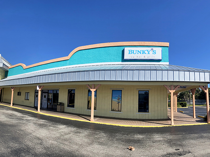The turquoise beacon of Bunky's stands out like a culinary lighthouse, promising seafood treasures within its unassuming strip mall setting.