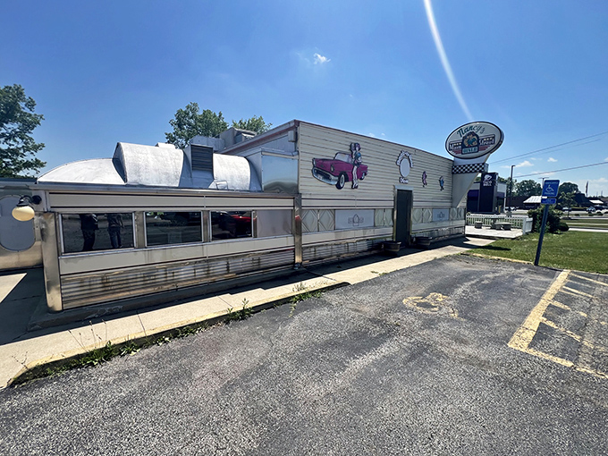 The classic stainless steel exterior gleams in the sunlight, a time capsule of Americana that promises comfort food and conversation inside.