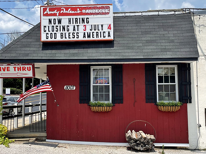 The giant pink pig on the roof isn't just decoration – it's a beacon of barbecue hope guiding hungry travelers to this rustic red barn-like paradise.