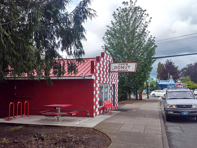 The red and white checkerboard exterior of Joe's Donut Shop stands like a sugary mirage on Highway 26, beckoning hungry travelers with promises of fried dough paradise.