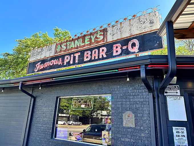 That neon glow against a Texas sunset isn't just a sign—it's a beacon of barbecue hope calling hungry pilgrims home.