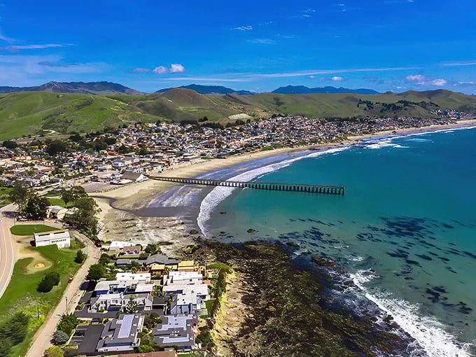The iconic Cayucos pier stretches into the Pacific like a wooden welcome mat, connecting the quaint town to the endless blue horizon.