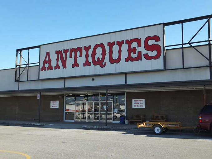 The red block letters spelling "ANTIQUES" aren't just a sign—they're a promise of treasure hunting adventures waiting just beyond those doors.