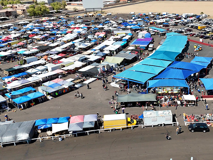 From above, it's a kaleidoscope of commerce—hundreds of canopies creating a temporary city where treasure hunters navigate the maze of possibilities.