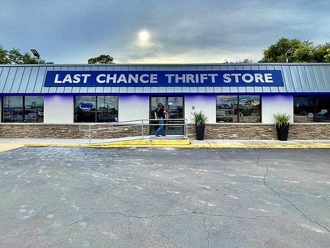 The blue awning beckons like a portal to treasure-hunting paradise. Last Chance Thrift Store's unassuming exterior hides a wonderland of possibilities within.