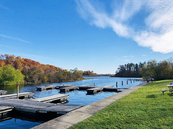 Nature's perfect mirror – Punderson Lake reflects autumn's fiery palette while boat docks patiently wait for the next adventure seeker.