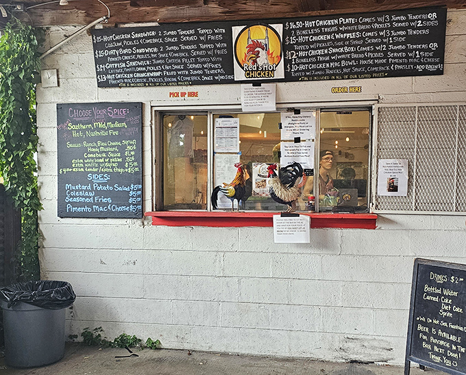 The unassuming interior of Red's Hot Chicken proves once again that culinary treasures often hide behind the simplest facades. That order window has seen countless Nashville heat seekers.
