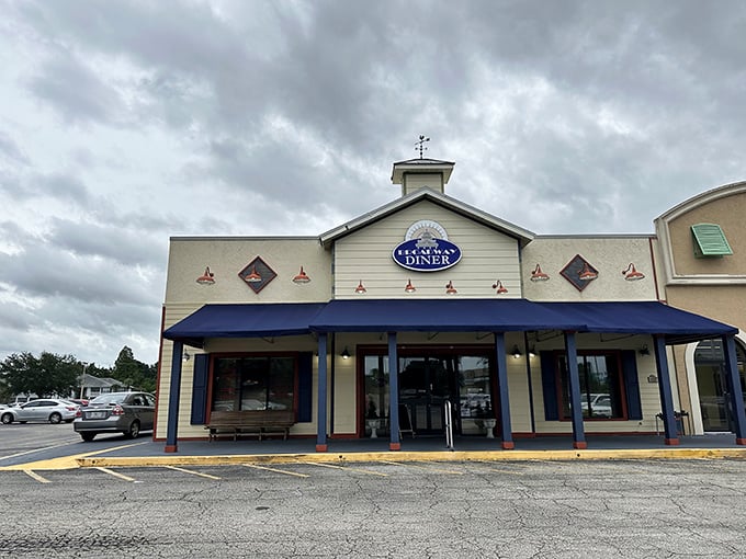 The welcoming facade of Broadway Diner in Bartow beckons with its classic blue awning and warm lighting—like a culinary lighthouse for hungry travelers.