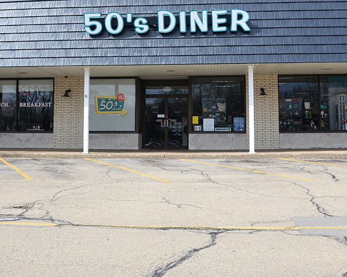 The blue neon sign of 50's Diner glows like a beacon for hungry travelers, promising a journey back to simpler times when calories didn't count and breakfast reigned supreme.