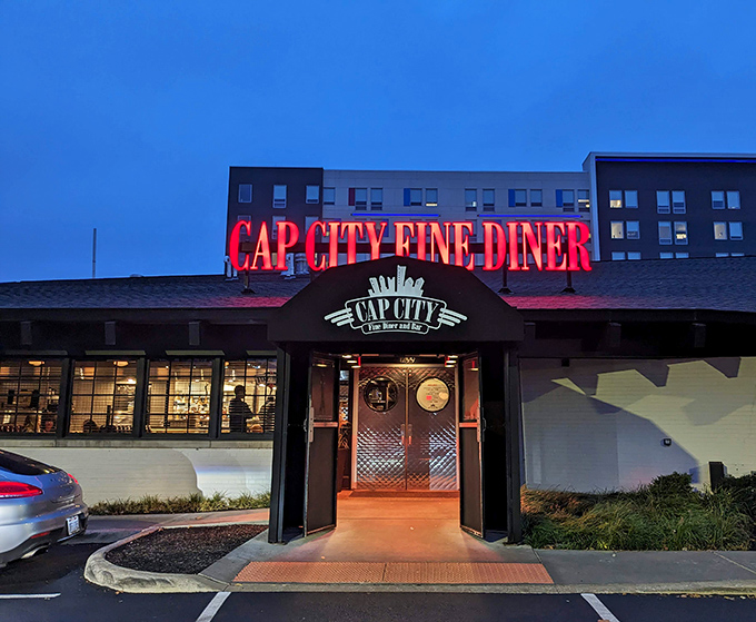The neon glow of Cap City's sign against the twilight sky isn't just illumination—it's a beacon calling hungry souls home to comfort food paradise.