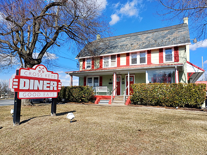 The charming red and white exterior of Cross Keys Diner stands like a beacon of breakfast hope in Doylestown, promising "GOOD EATS" that deliver on every syllable.