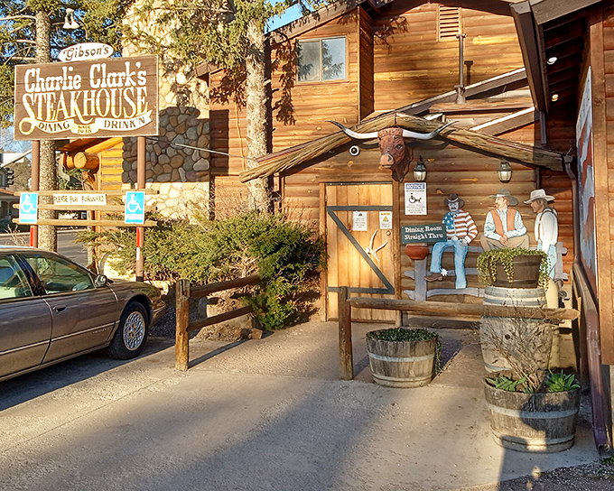 The rustic log cabin exterior of Charlie Clark's isn't just inviting—it's practically whispering "come in and loosen your belt" to hungry travelers.