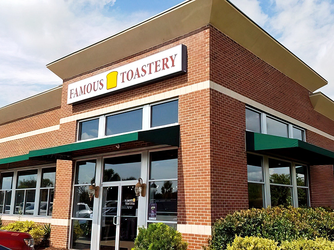 The cheerful yellow toast icon on Famous Toastery's sign is like a beacon for breakfast enthusiasts—promising morning salvation in brick-and-mortar form.