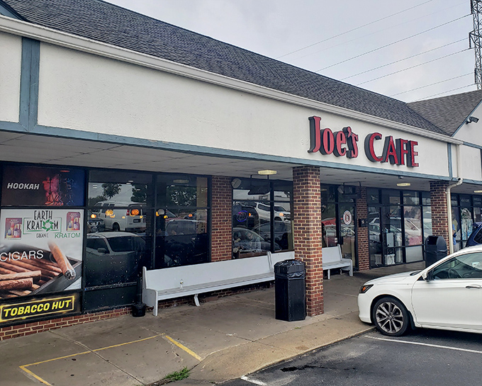 The iconic red lettering of Joe's Cafe stands as a beacon of comfort food in Sterling, where patriotic bunting and bench seating welcome hungry visitors year-round.
