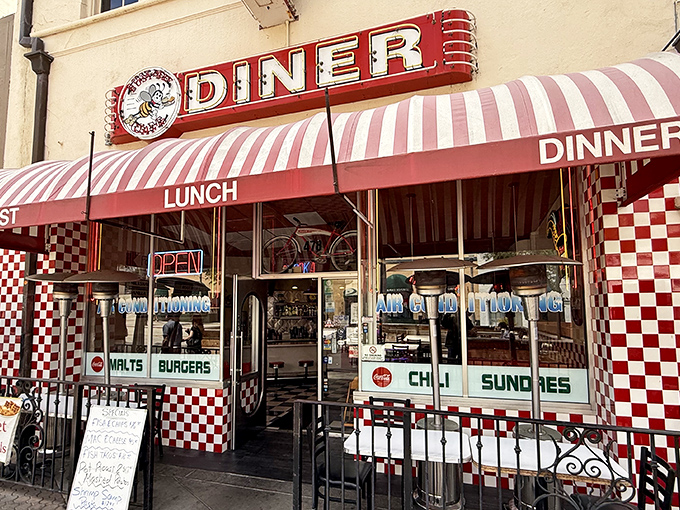 The red and white checkered facade isn't just inviting—it's practically shouting "Get in here and eat something wonderful!" Classic Americana at its finest.