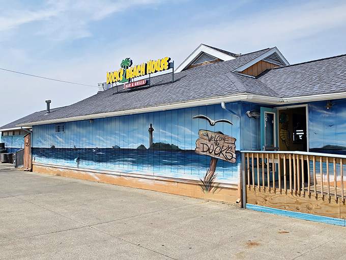 That stunning lakeside mural transforms an ordinary building into your personal tropical getaway fantasy.