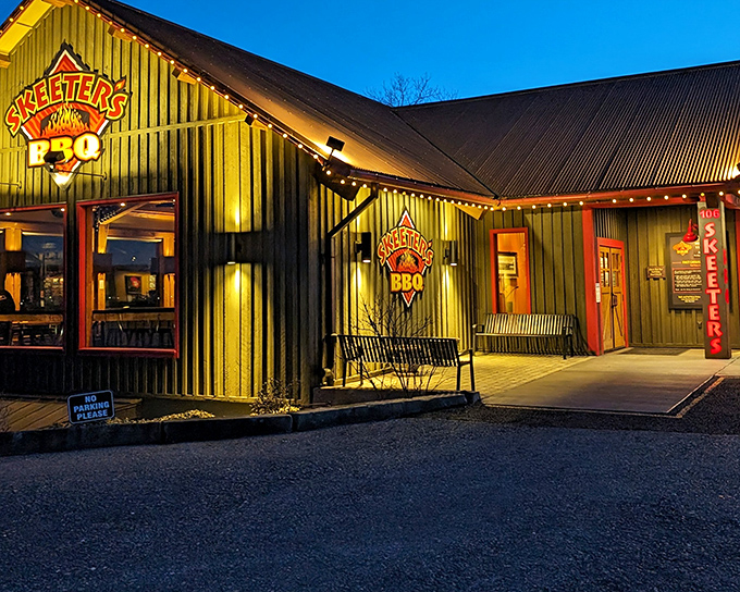 The green exterior with red trim of Skeeter's BBQ isn't trying to impress anyone—it's saving all that energy for what happens inside those smokers.
