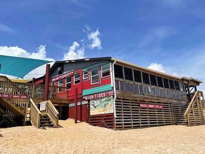 This isn't just a restaurant on the beach—it's practically IN the beach. Red and teal weathered wood that's seen a thousand sunsets and keeps on smiling.