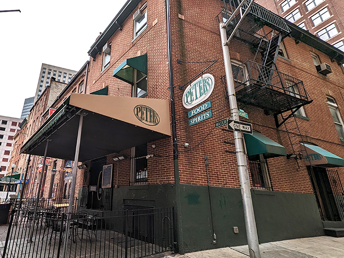 The unassuming brick exterior of Peter's Pour House beckons with its classic green awning and Irish flag—a culinary treasure hiding in plain sight.