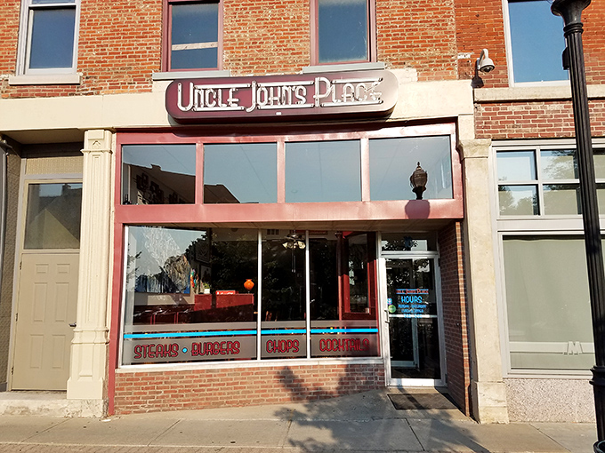 The neon glow of Uncle John's Place sign beckons like a lighthouse for the hungry. Downtown Mansfield's worst-kept culinary secret since 1977. 
