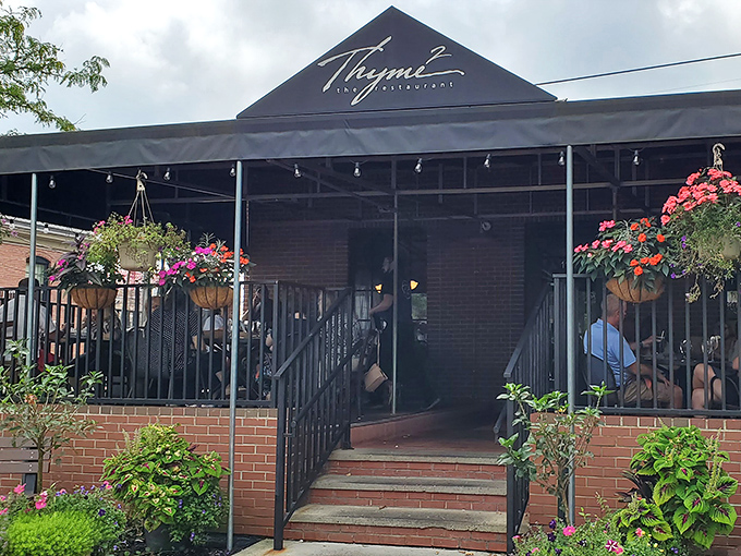 Thyme2's inviting exterior welcomes you with colorful hanging flower baskets and a covered patio—like a culinary hug before you even step inside.
