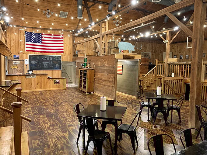The rustic red exterior of Big Dan's BBQ belies the smoky treasures within. Those pink picnic benches? Nature's way of saying "sit here after your meat sweats begin."
