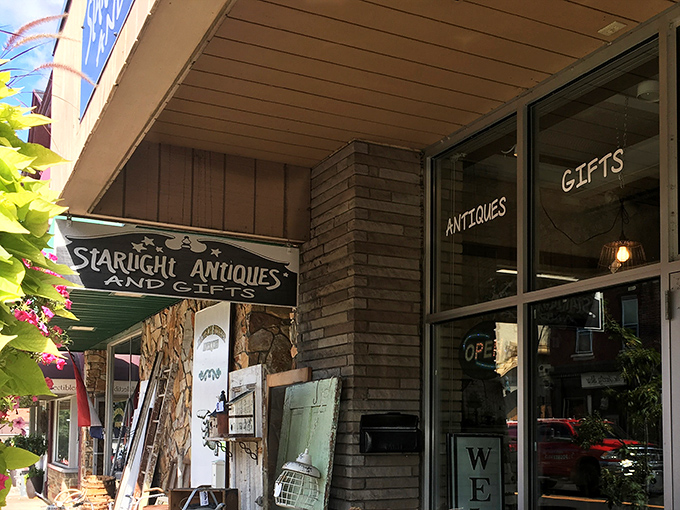The storefront beckons like an old friend with treasures spilling onto the sidewalk. That orange traffic cone? Probably directing traffic to the bargains inside. 