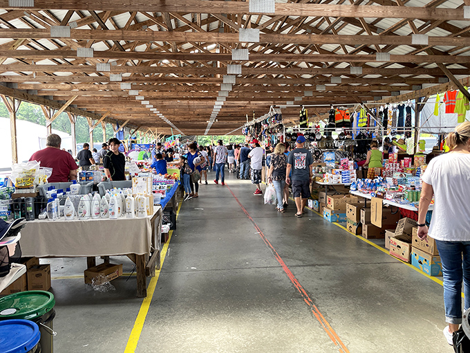 The covered walkways of Webb Road Flea Market stretch like a runway for bargain hunters, where treasures await under rustic wooden beams.