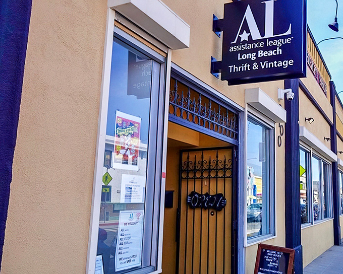 The navy blue façade of Assistance League Thrift Shop stands proudly on the street, like a treasure chest waiting to be opened by curious bargain hunters.