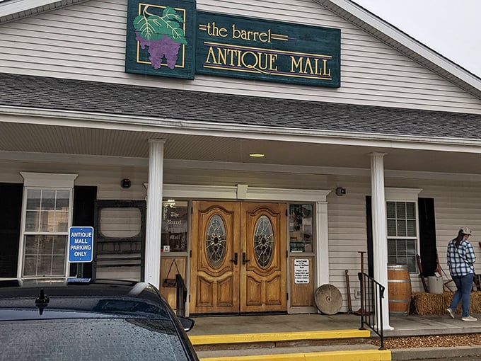 The welcoming facade of The Barrel Antique Mall beckons with its charming porch and elegant wooden doors—a modest exterior that belies the wonderland within.