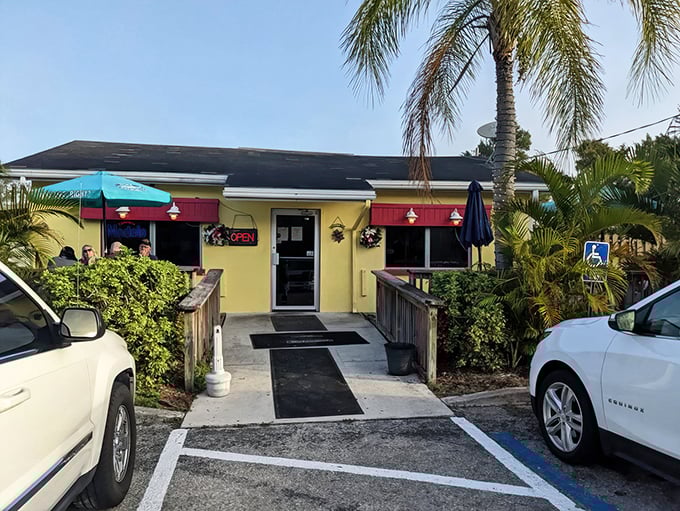 The sunny yellow exterior of Leo's French Toast House with its red awnings isn't just inviting—it's practically giving you a hug before you even walk in.