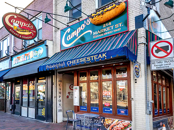 The siren call of sandwich paradise—Campo's iconic storefront on Market Street, complete with that glorious 3D cheesesteak sign that should qualify as public art.