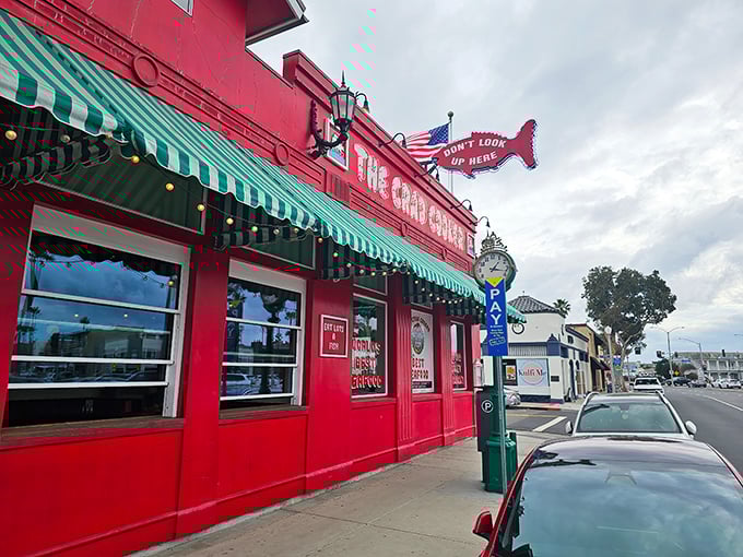 The fire-engine red exterior of The Crab Cooker stands out like a culinary lighthouse, complete with that iconic fish sign practically shouting "seafood paradise ahead!"